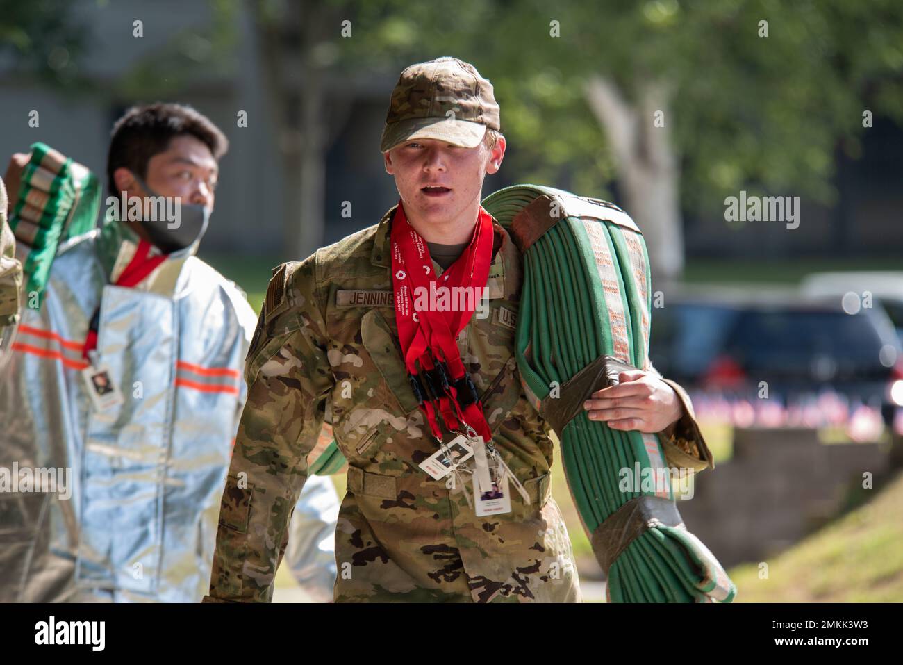 A member of Team Misawa carries a folded fire hose during the annual 9/ ...