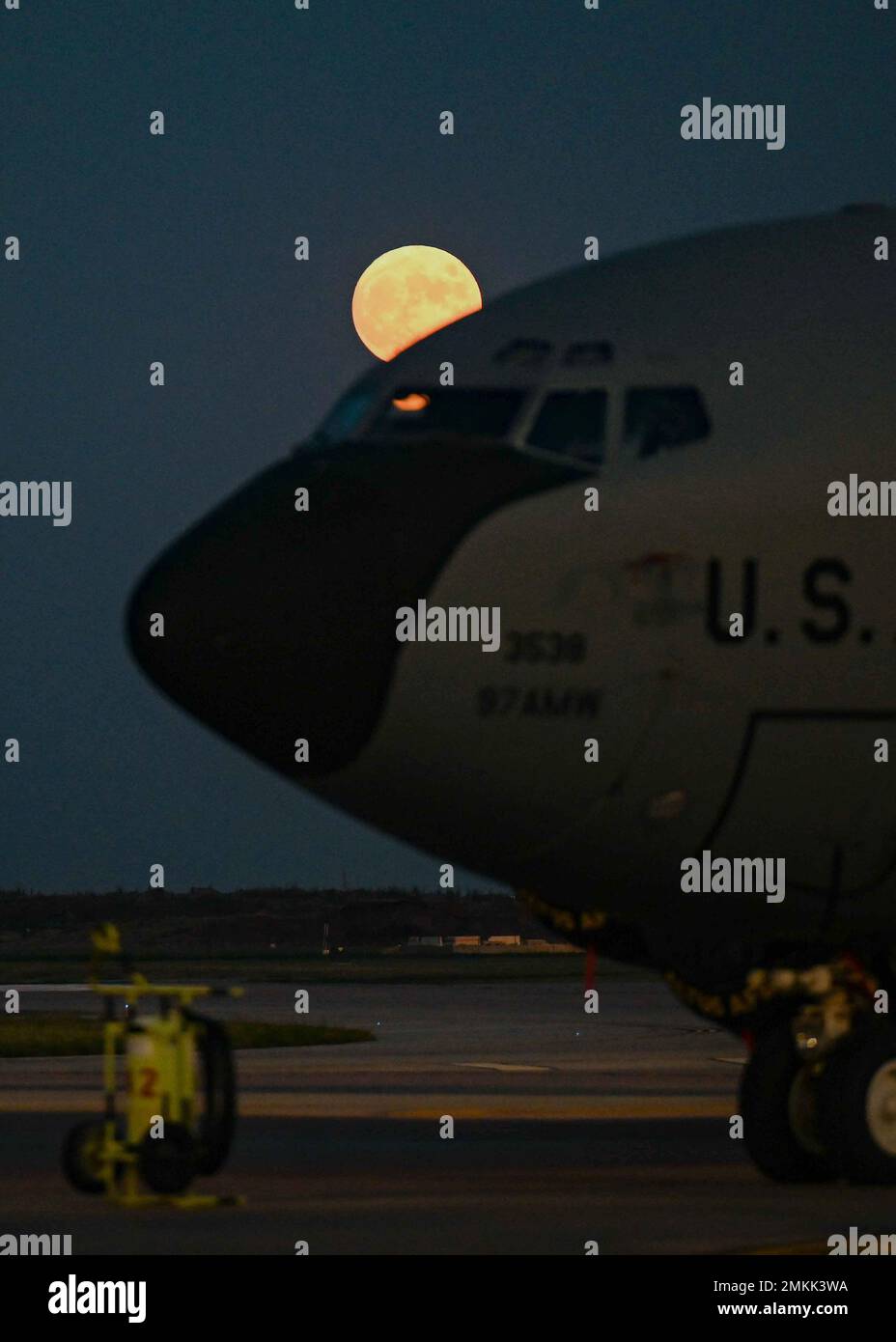 A full moon rises over a KC-135 Stratotanker, September 9, 2022, at Altus Air Force Base ...