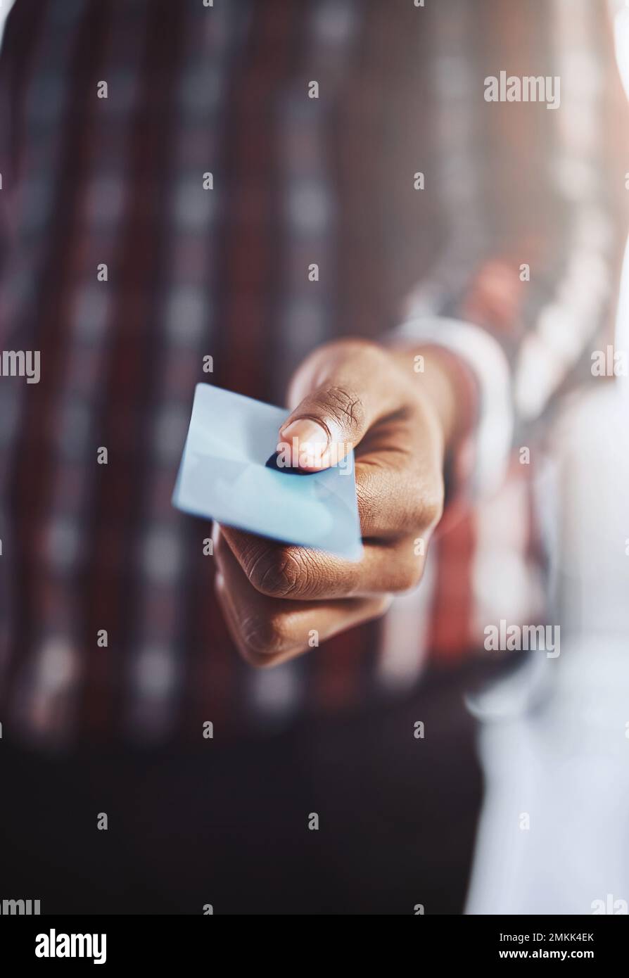 He never misses a payment. an unrecognizable man holding his card out ...