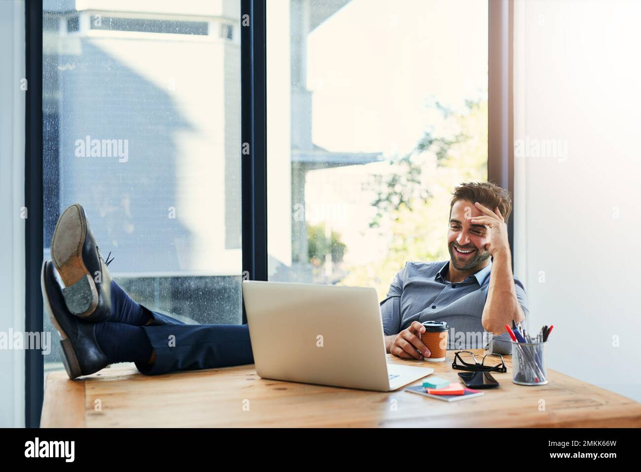 Relaxed young businessman with laptop hi-res stock photography and ...