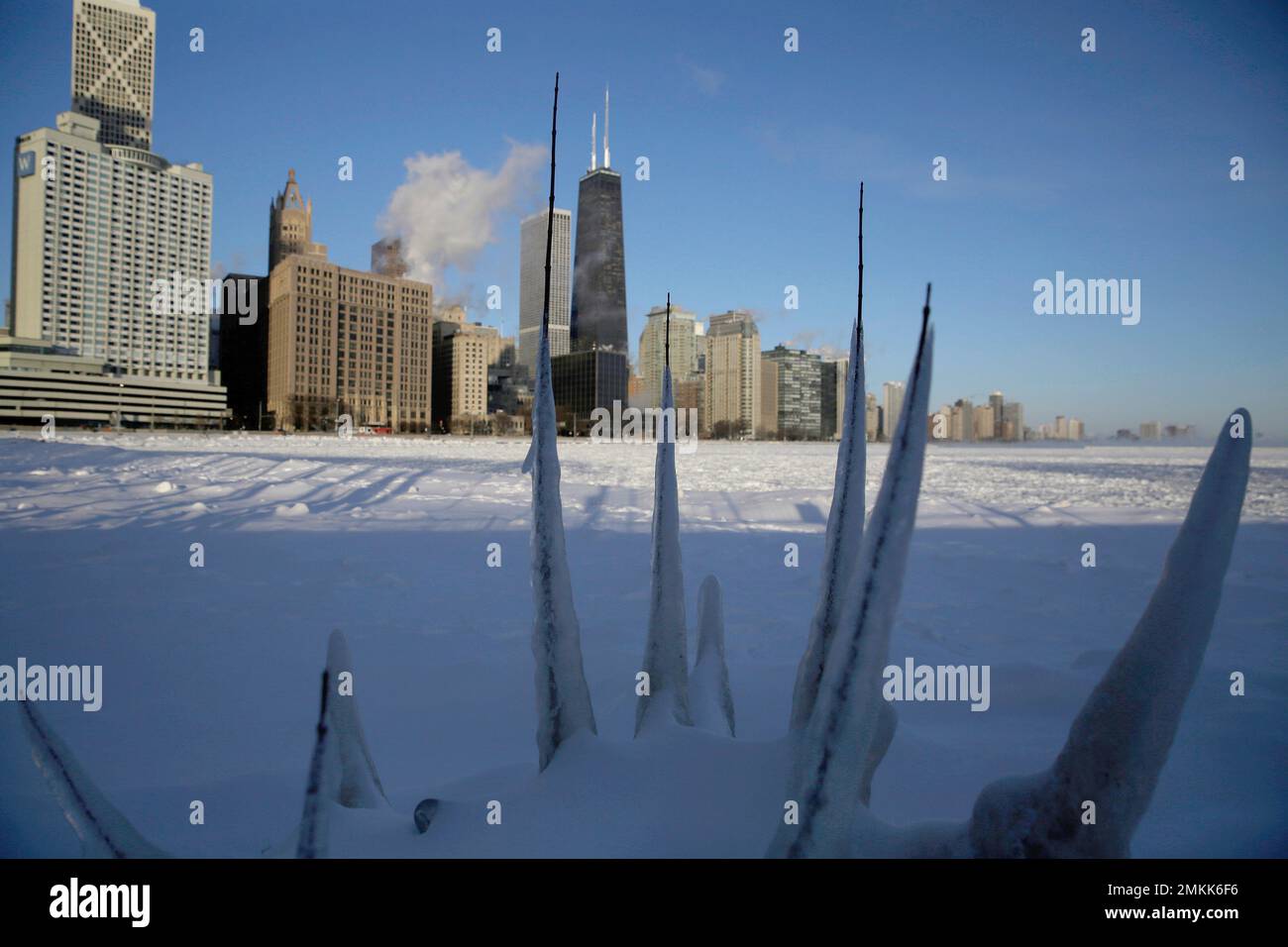 Ice forms along the shore of Lake Michigan before sunrise, Wednesday ...