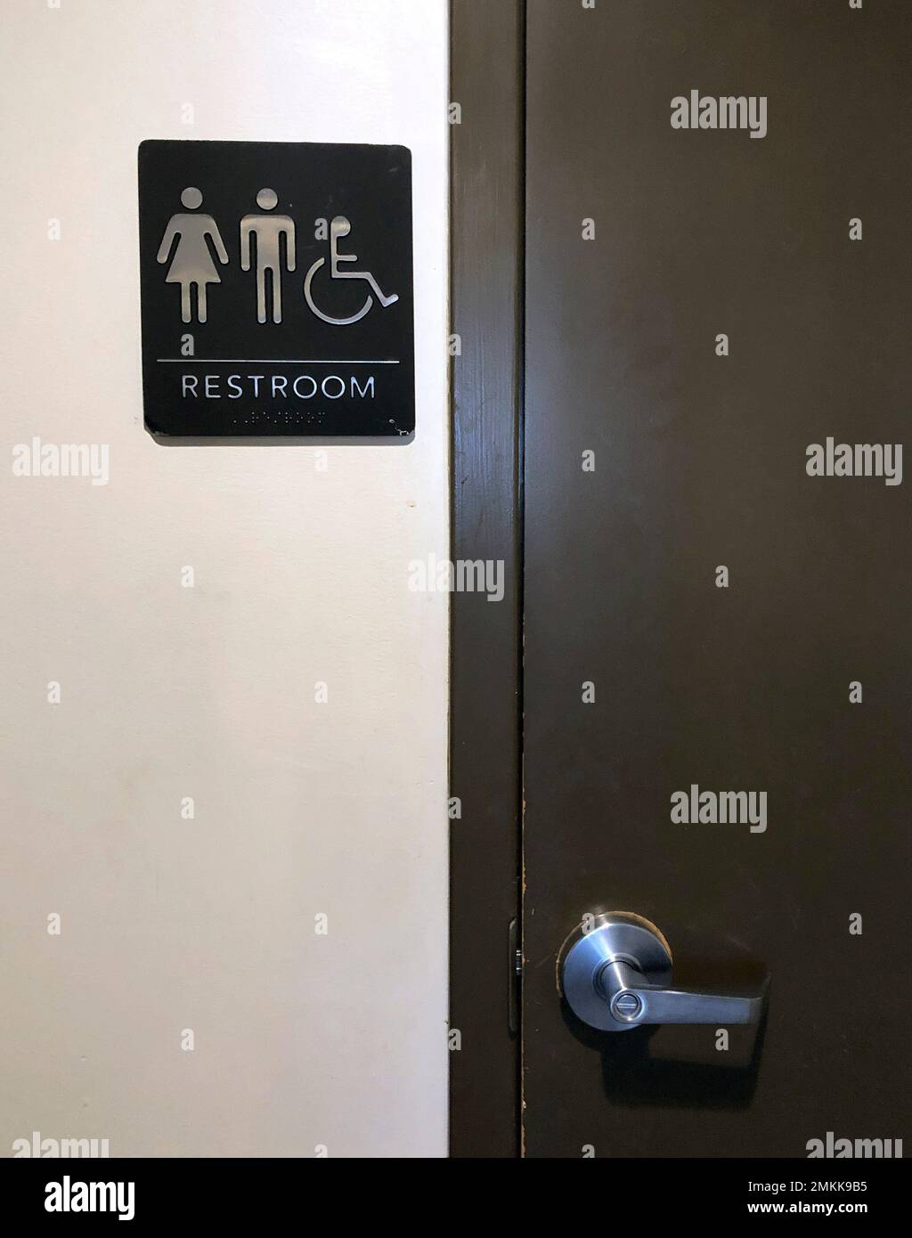 A sign is posted on a restroom door for general use by all patrons in a ...