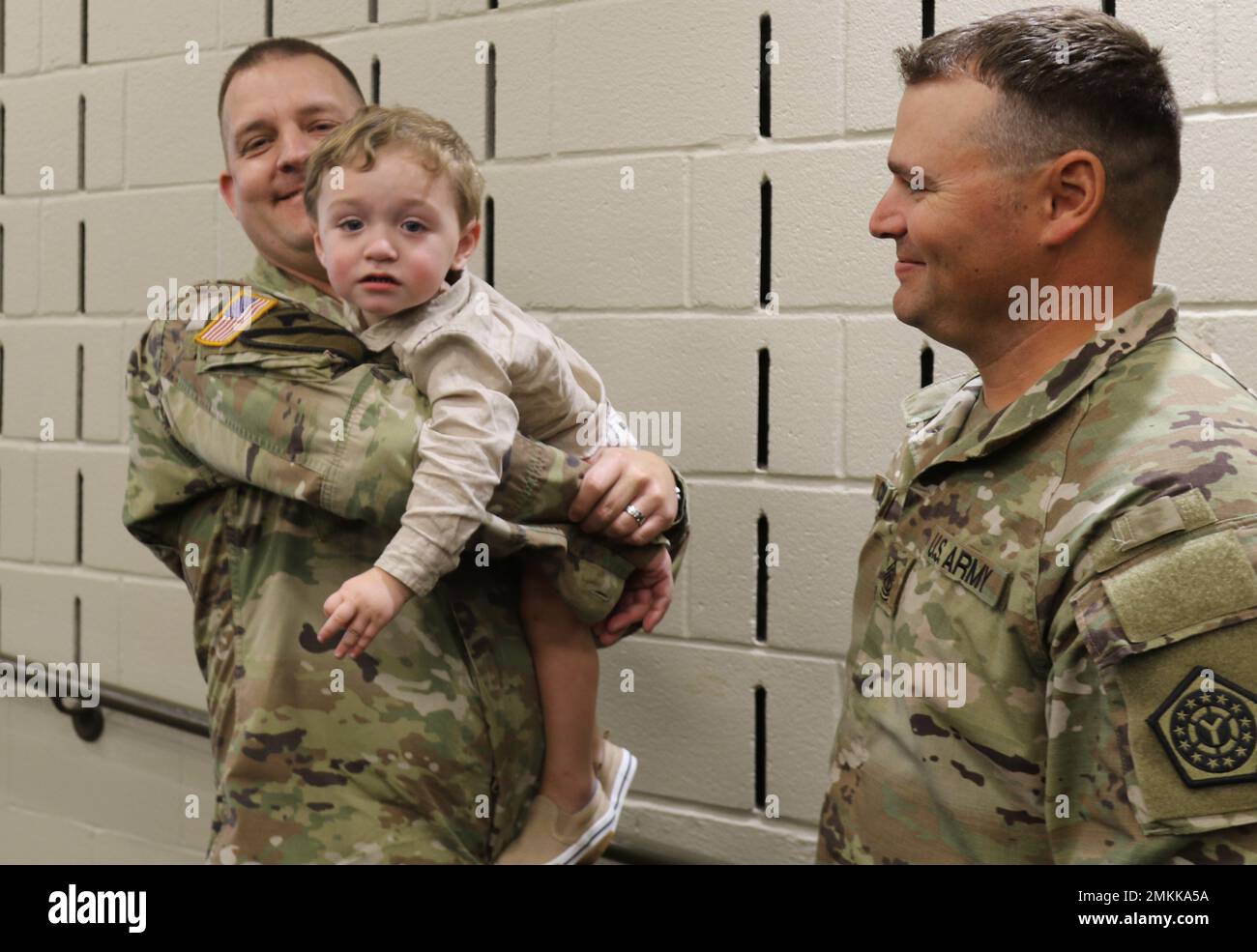 Two-year-old Jagger Heleine looks out from his father's arms. His ...