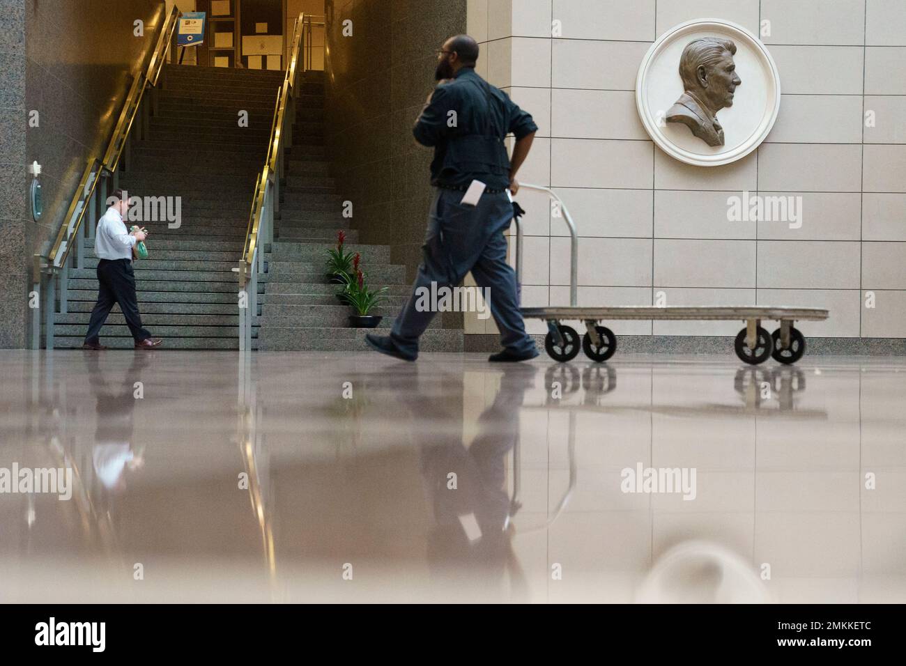 People walk through the atrium of the Ronald Reagan Building and ...
