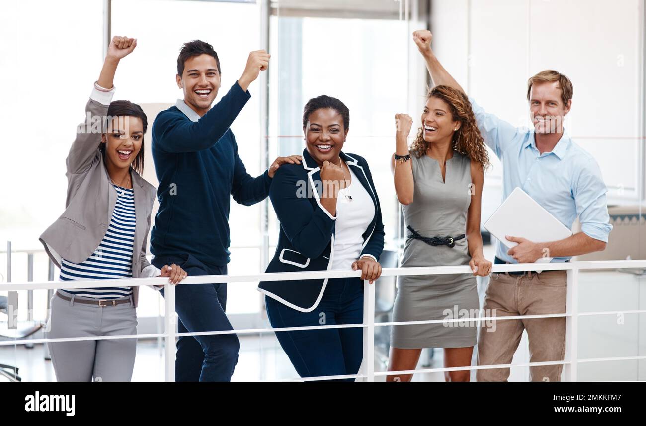 This is what success looks like. a diverse group of colleagues celebrating success with their ...