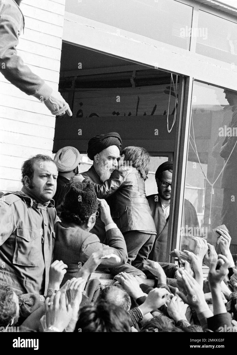 A young boy gives Ayatollah Ruhollah Khomeini a kiss, Feb. 7, 1979, as ...