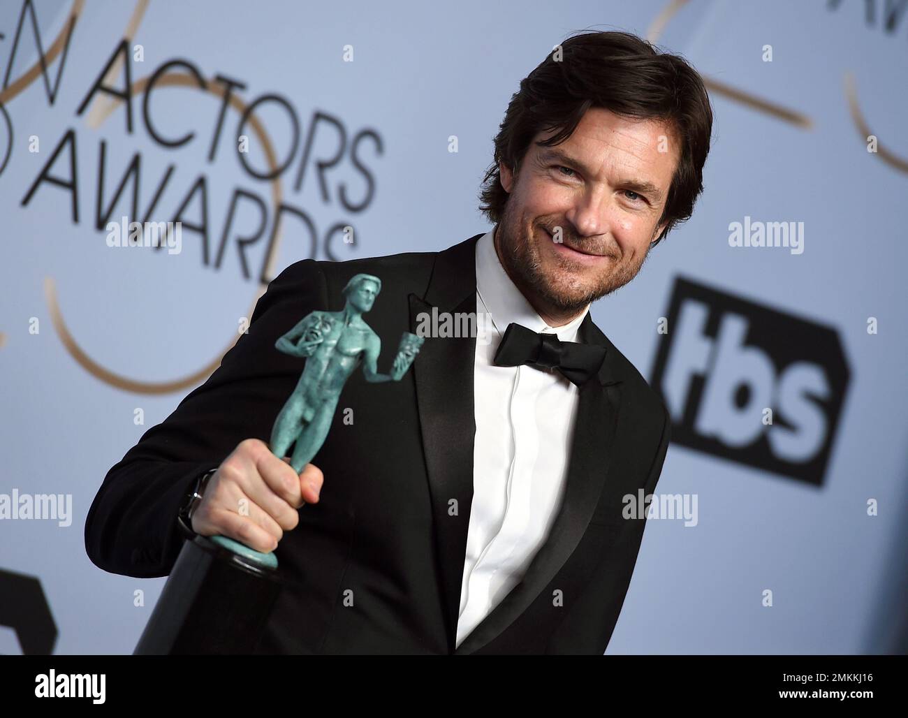 Jason Bateman poses with the award for outstanding performance by a ...