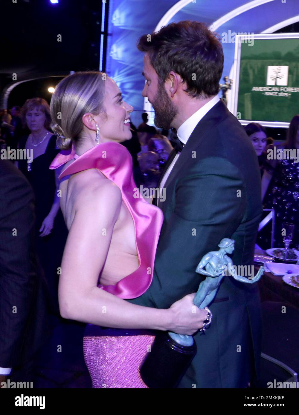 John Krasinski, right, embraces Emily Blunt, winner of the award for outstanding performance by ...