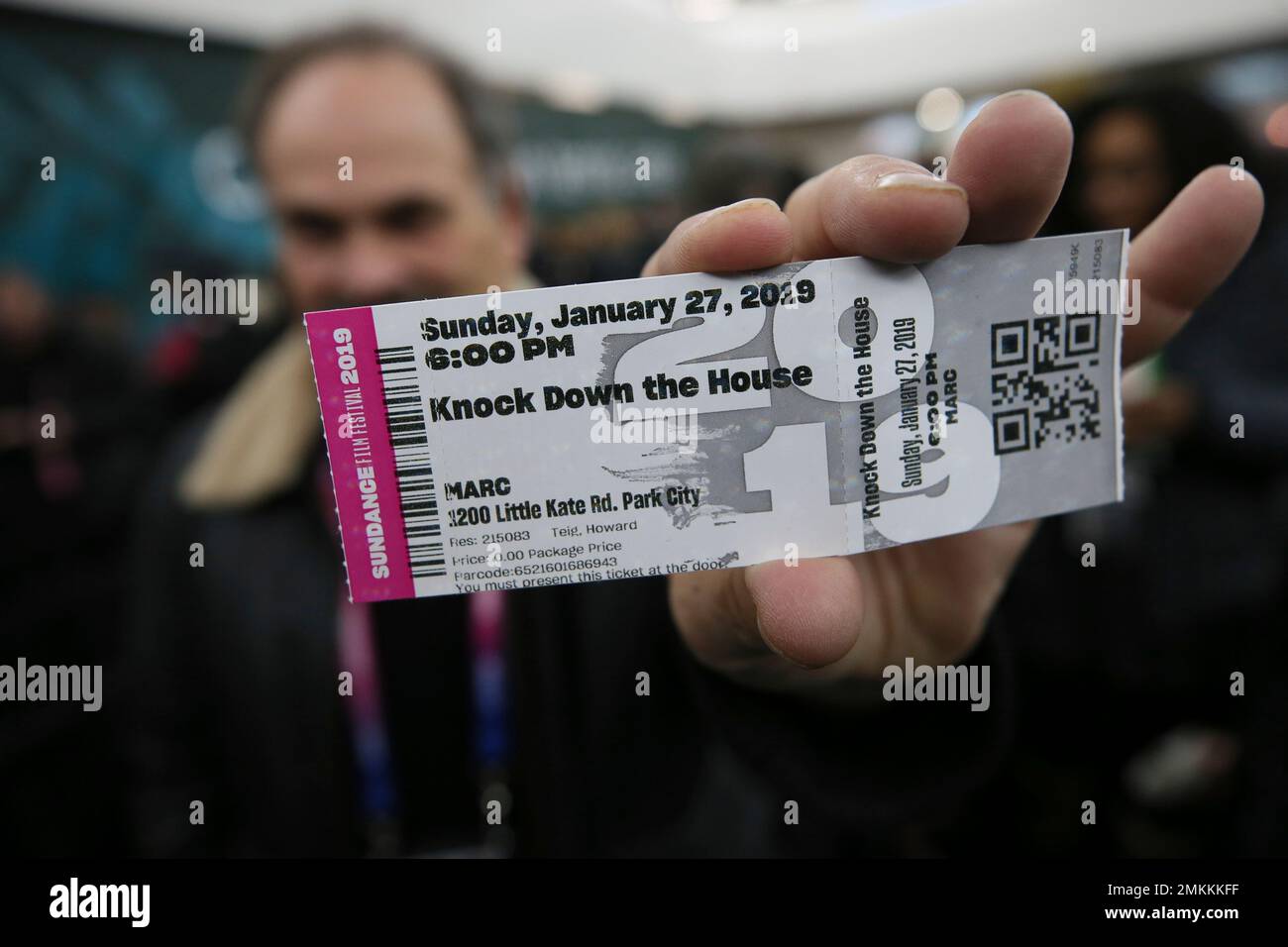 Howard Teig, from New York, holds up his ticket at the front of the ...