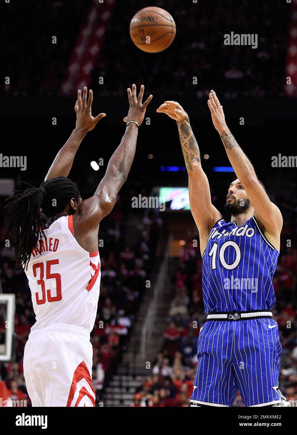 Orlando Magic guard Evan Fournier, right, shoots as Houston Rockets ...