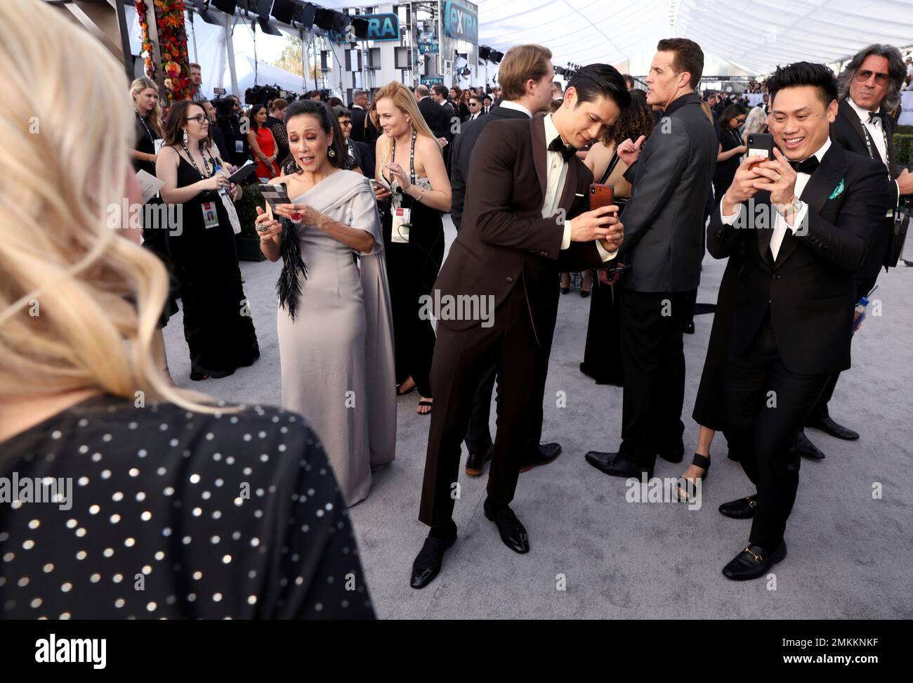 Harry Shum Jr., center, and Jon M. Chu, right, take pictures on the red ...