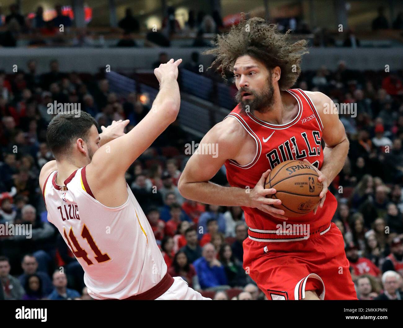 Chicago Bulls center Robin Lopez, right, drives against Cleveland ...