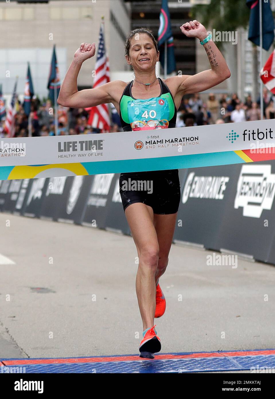 Kate Landau, of Tacoma, Wash., crosses the finish line to win the women ...