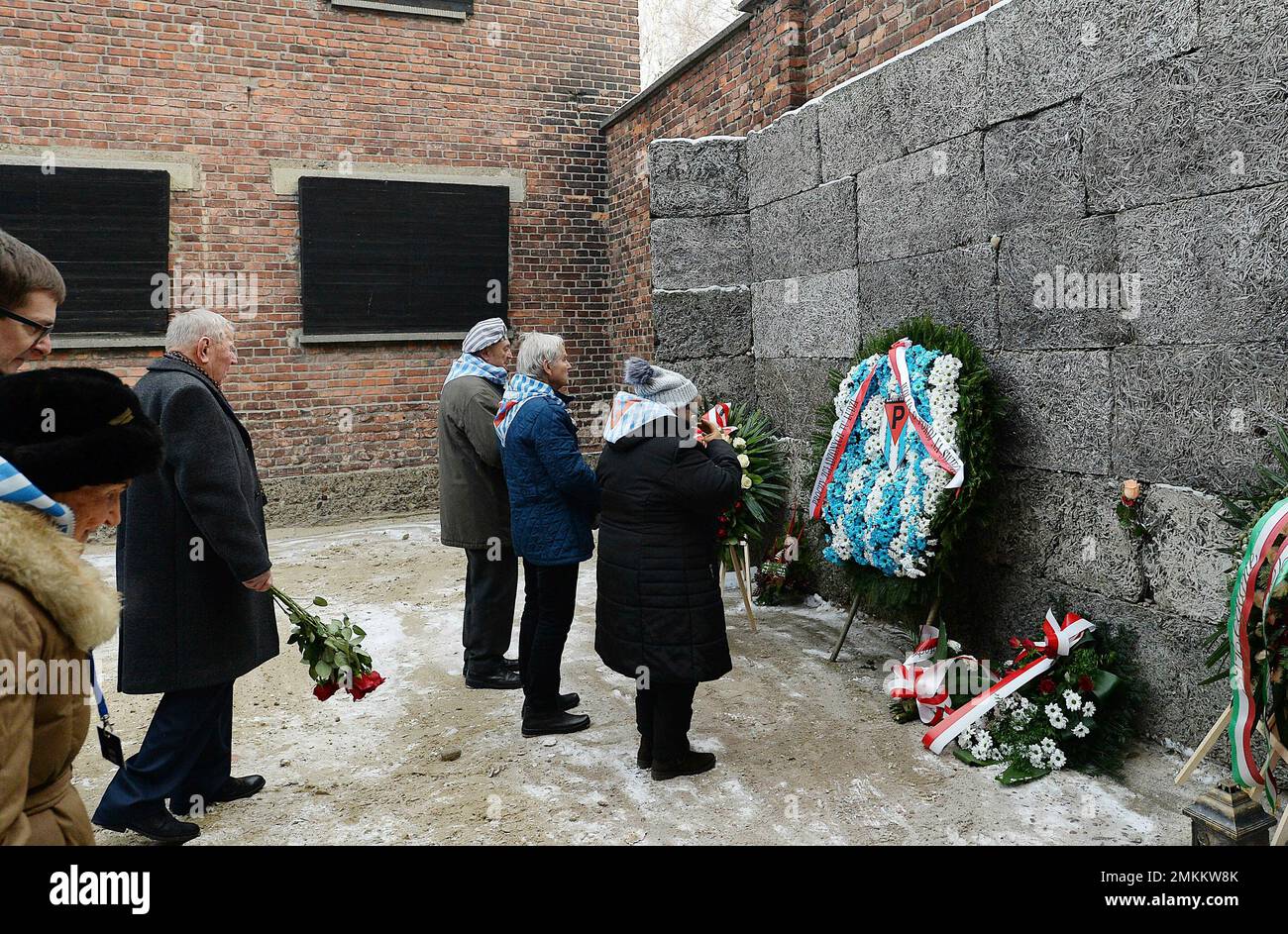 Former prisoners place candles and flowers at the Death Wall marking ...