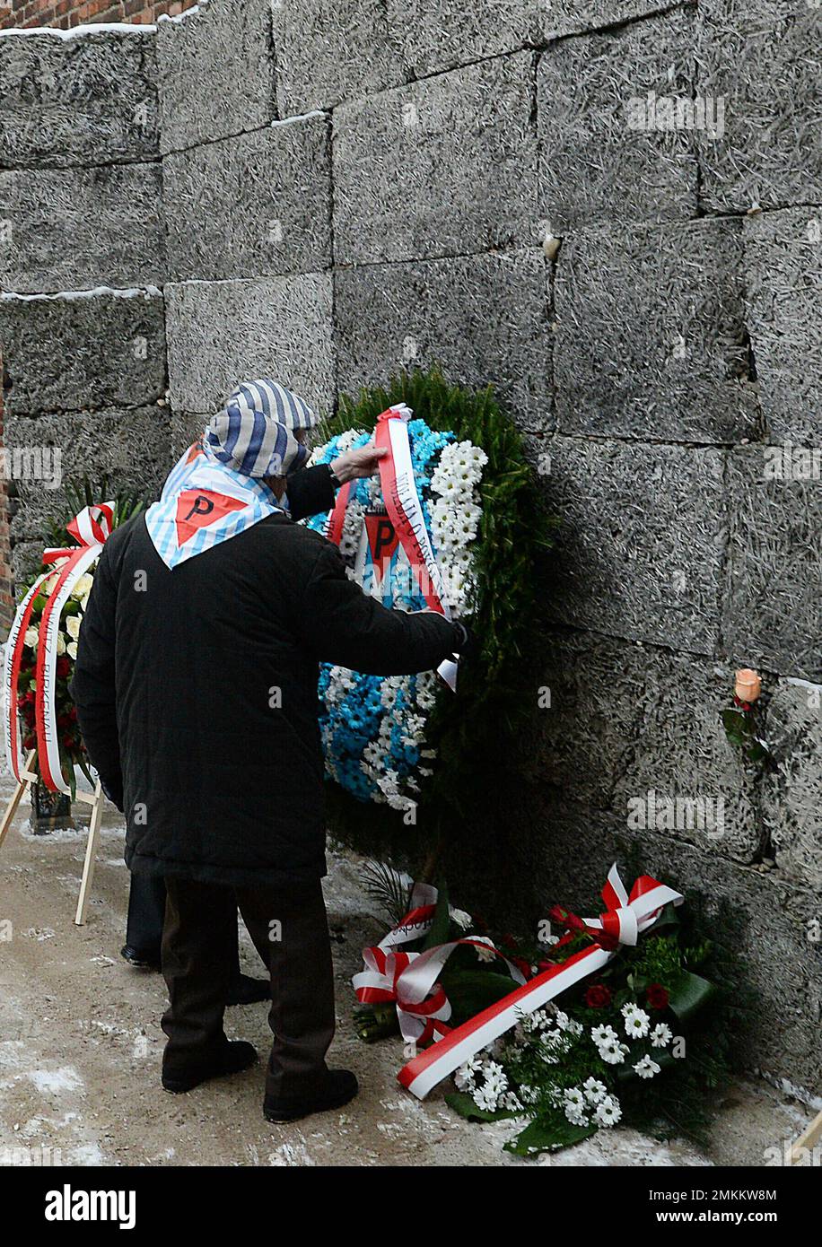Former prisoners place candles and flowers at the Death Wall marking ...