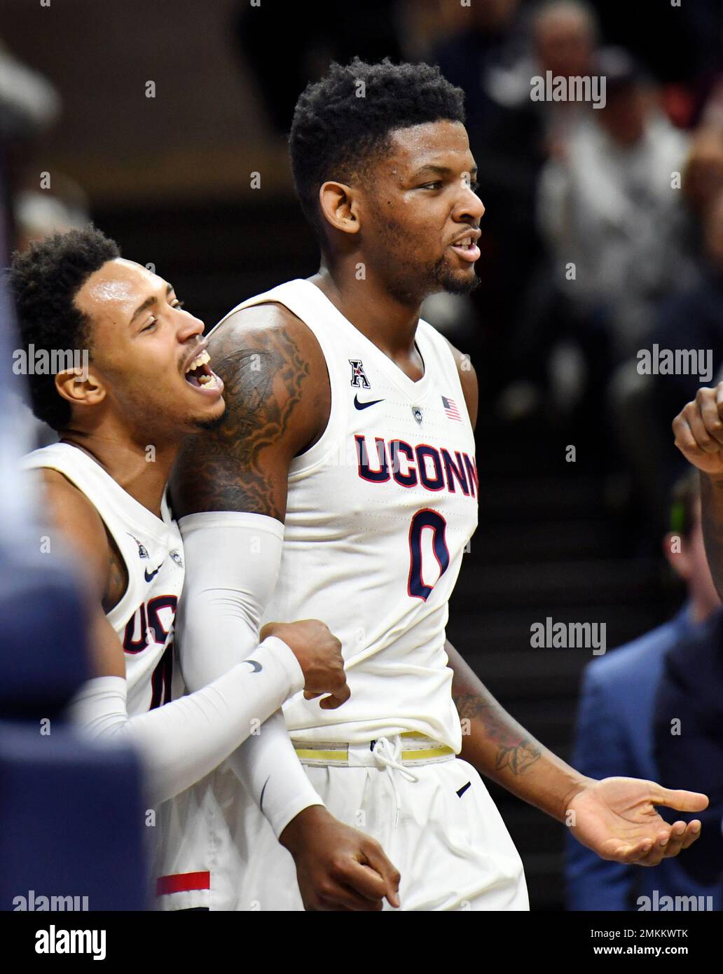 Connecticut's Eric Cobb (0) and Jalen Adams (4) celebrate near the end ...