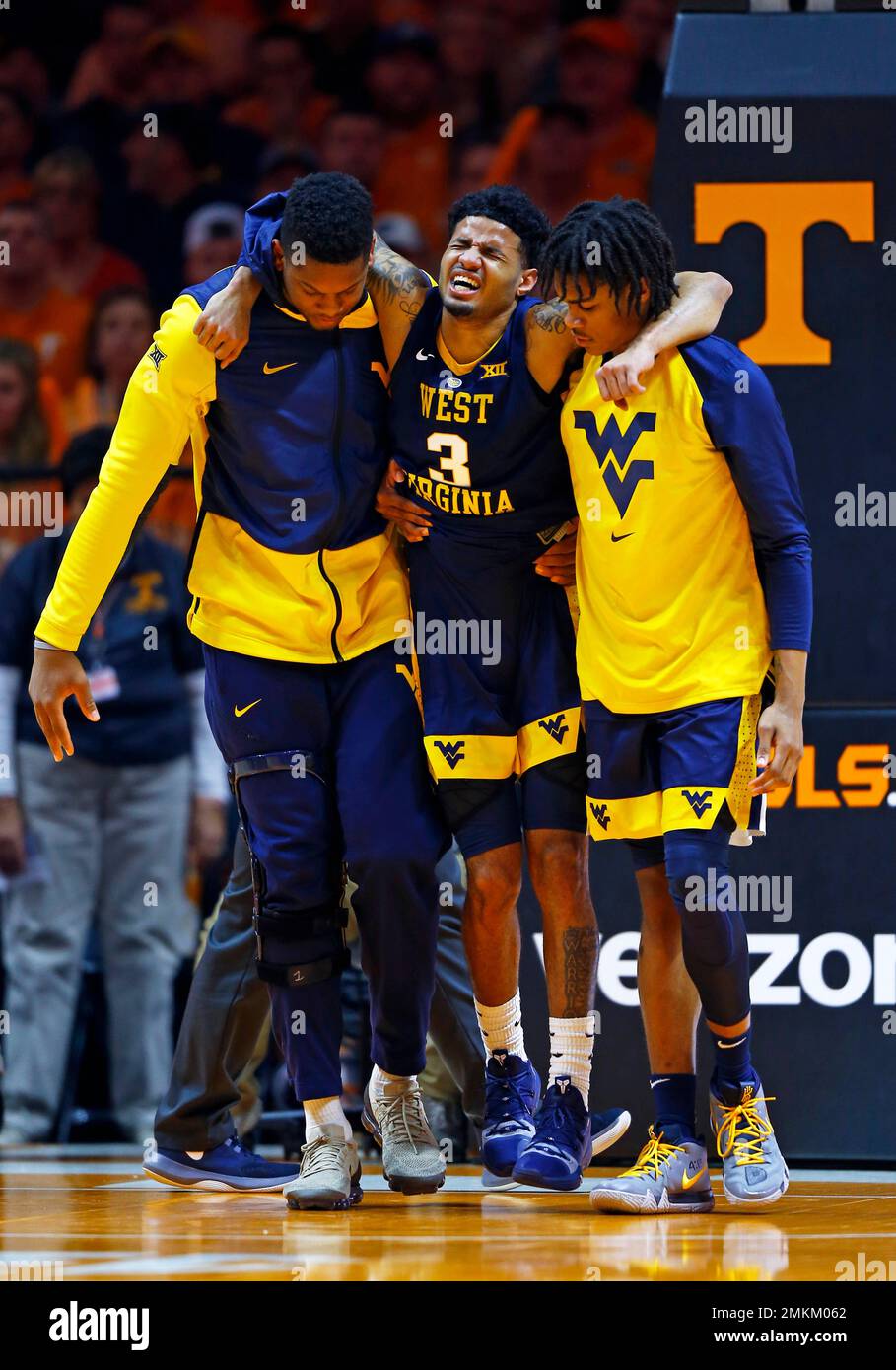 West Virginia guard James Bolden (3) is helped off the court after ...