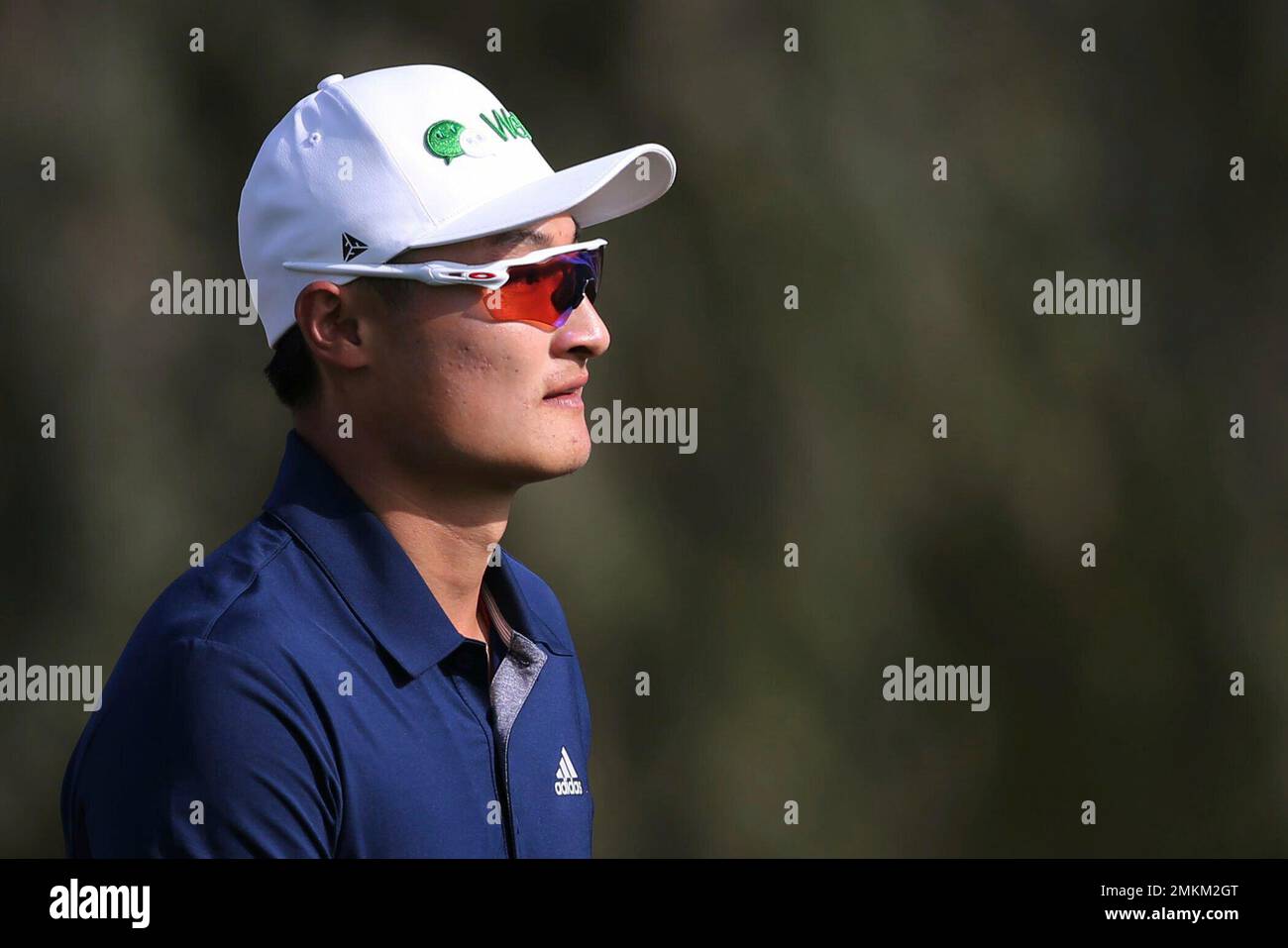Haotong Li of China walks on the 14th hole during round three of the ...