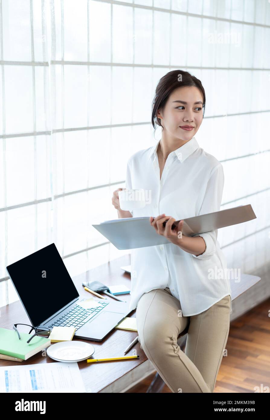 Check the documentation business woman Stock Photo - Alamy