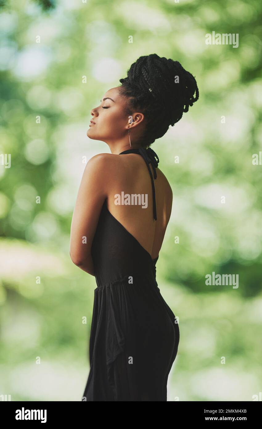 Feeling the cool sensations of nature on her skin. an attractive young ...