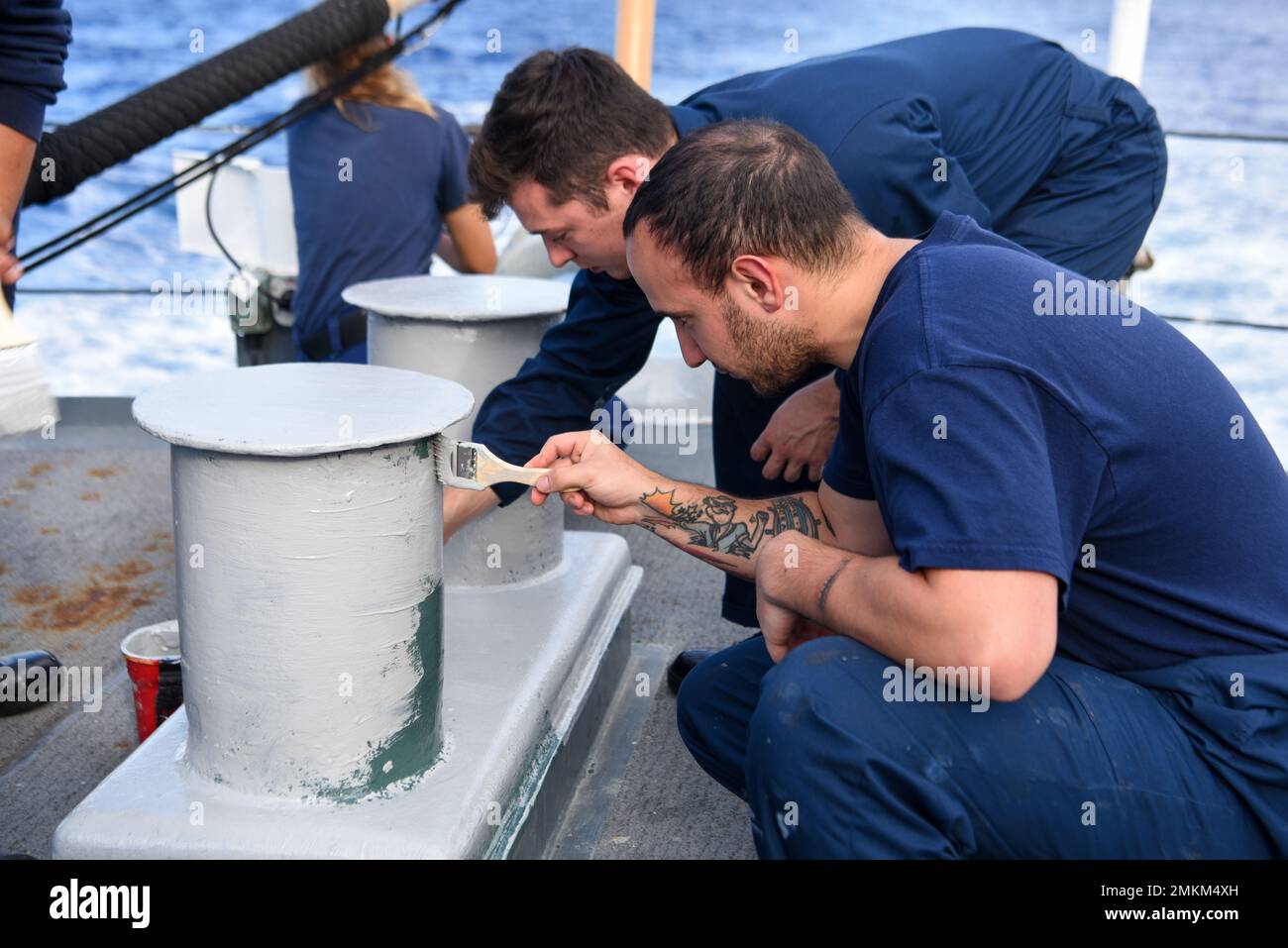 U.S. Coast Guard Petty Officer 3rd Class Daniel Fernandez repaints the ...
