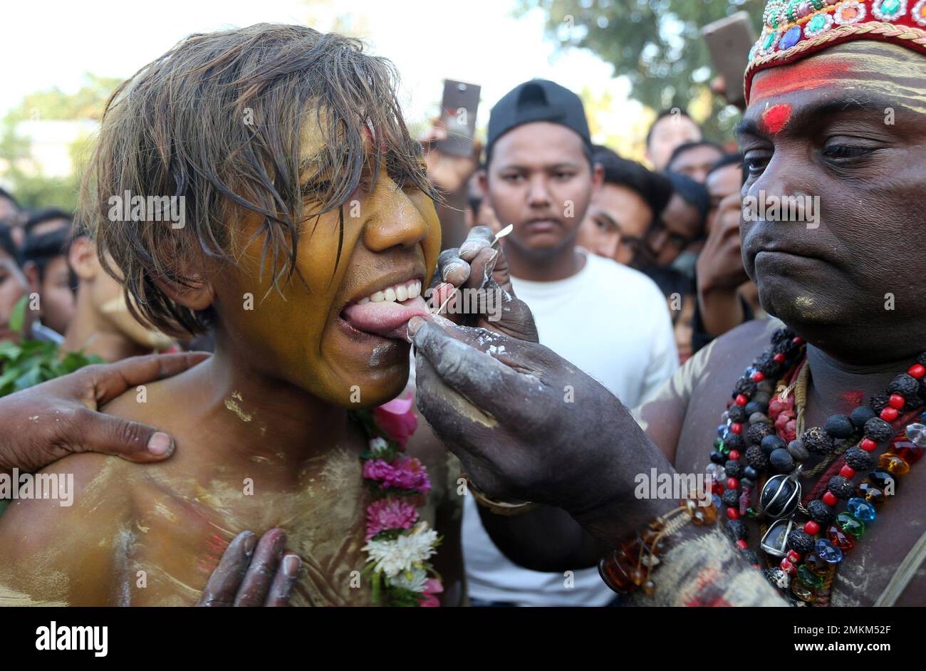In this Friday, Jan. 25, 2019, photo, a Hindu devotee pierces a Hindu ...