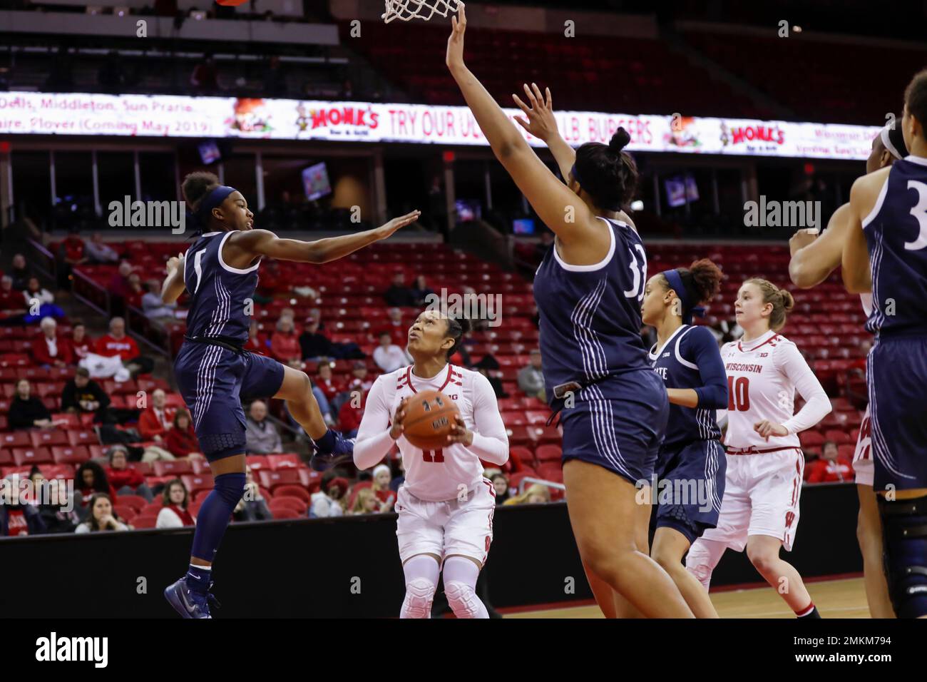 Wisconsin's Marsha Howard (11) shoots between Penn State's Kamaria McDaniel (5) and Lauren Ebo ...