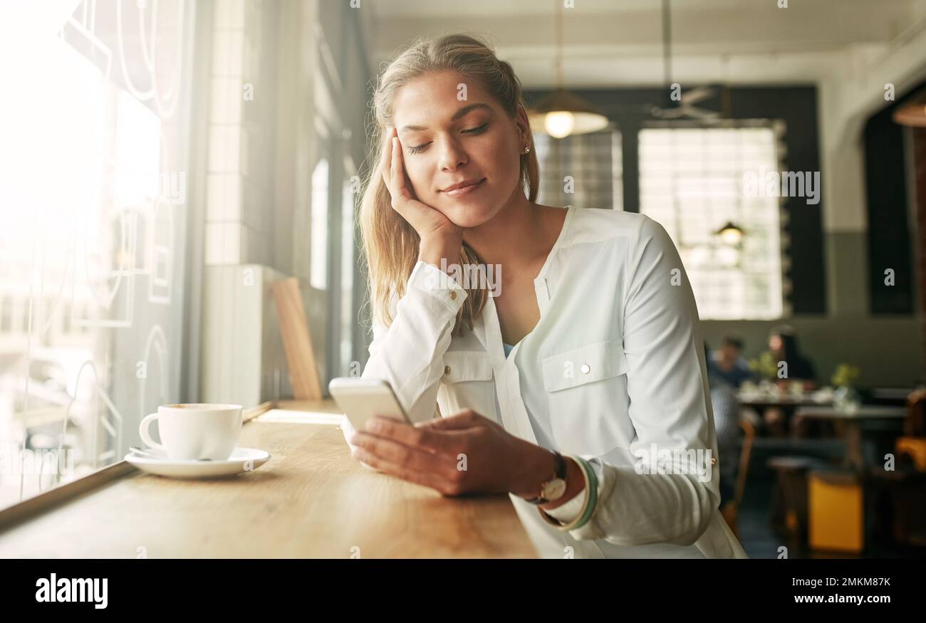 Having a laid back time at her favorite coffee shop. an attractive ...