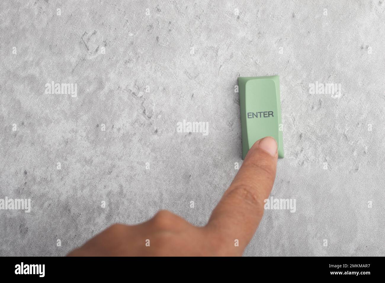 Finger pressing Enter button on gray background.Copy space Stock Photo ...