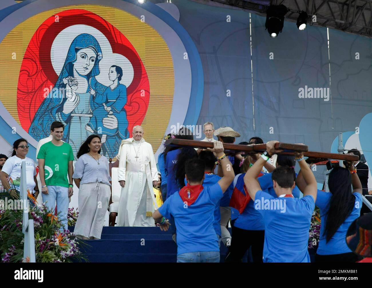 Youths bring the wooden cross of the World Youth day on the stage as ...
