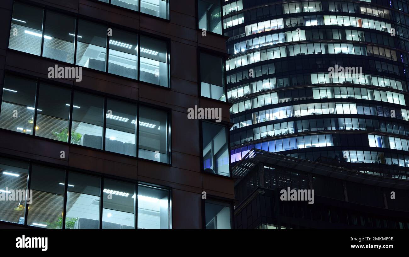 Pattern of office buildings windows illuminated at night. Glass ...
