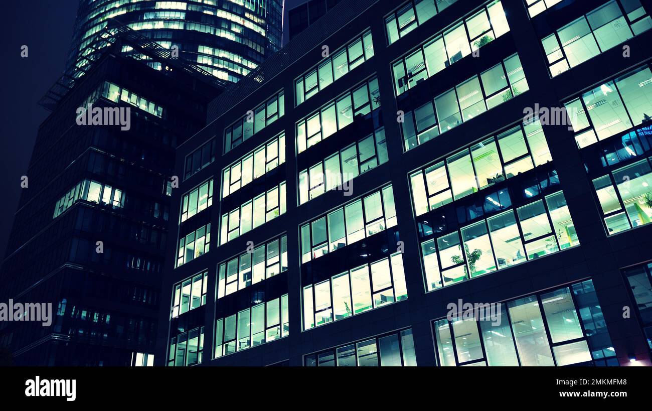 Pattern of office buildings windows illuminated at night. Glass ...