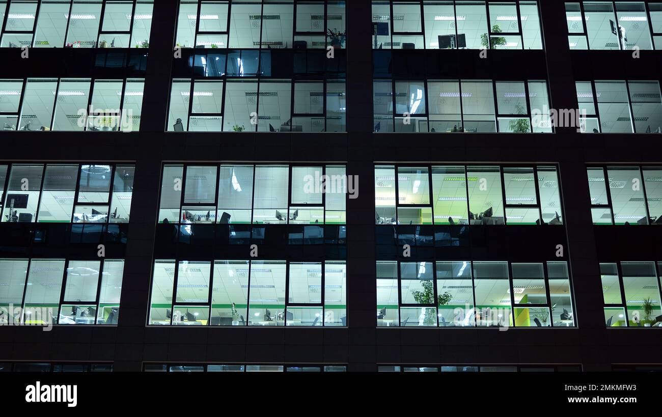 Corporate building at night - business concept. Glass wall office ...