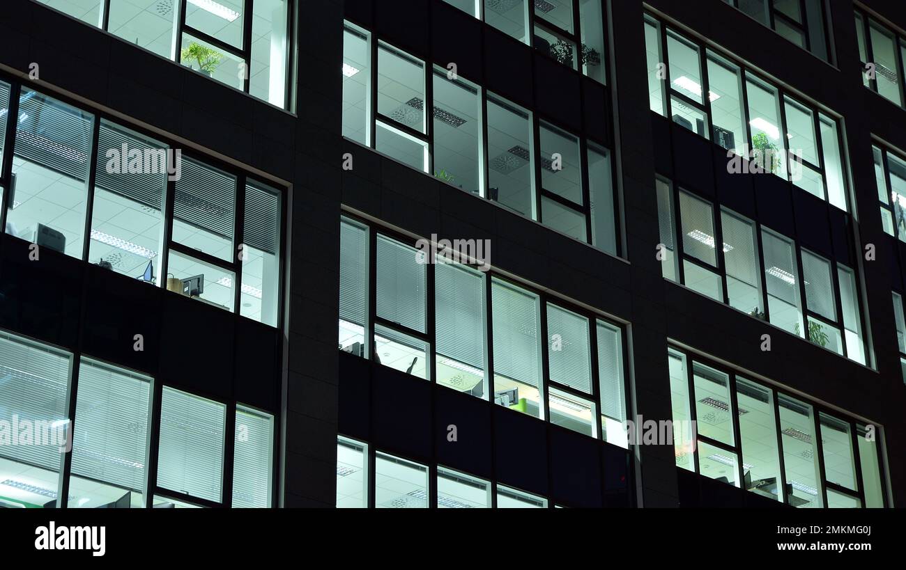 Corporate building at night - business concept. Glass wall office ...