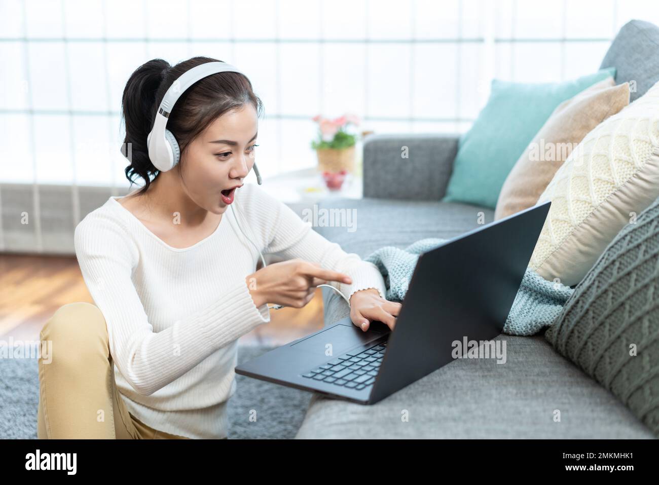 A young woman to use a computer at home Stock Photo - Alamy