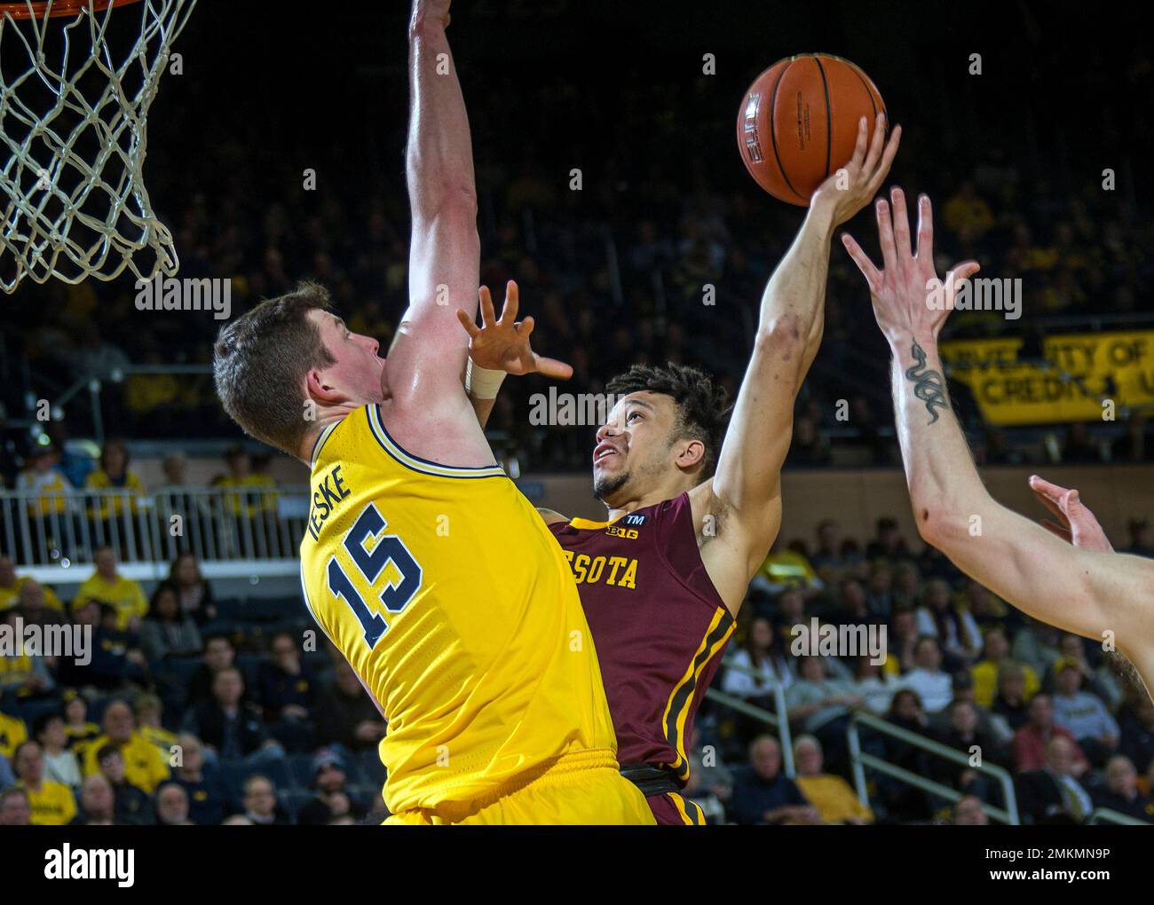 Michigan center Jon Teske (15) defends a shot attempt from Minnesota ...