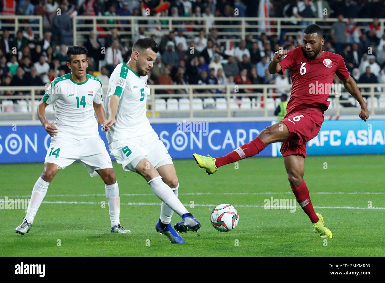 Iraq's defender Ali Faez, left, clears the ball ahead of Qatar's ...