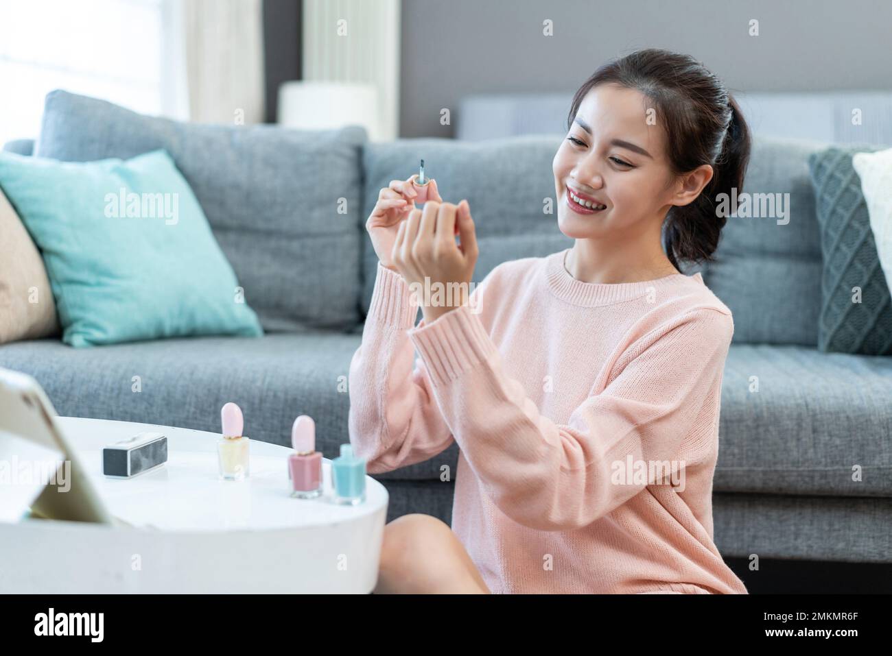 The young lady wear nail polish at home Stock Photo - Alamy