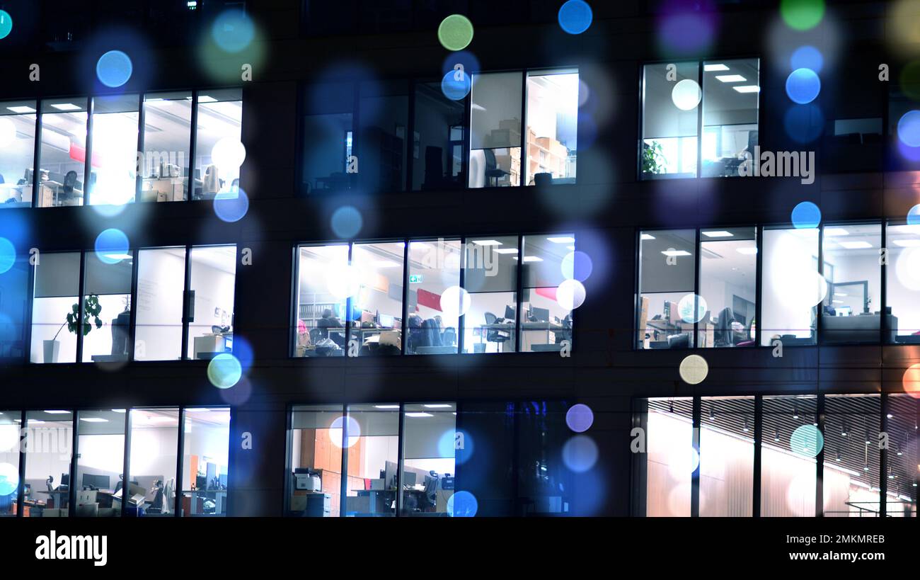 Pattern of office buildings windows illuminated at night. Glass ...