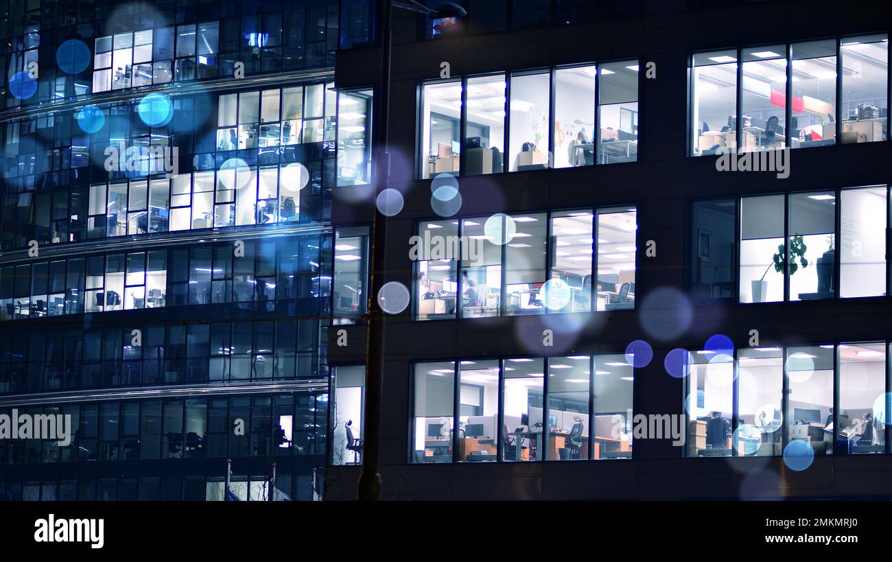 Pattern of office buildings windows illuminated at night. Glass ...