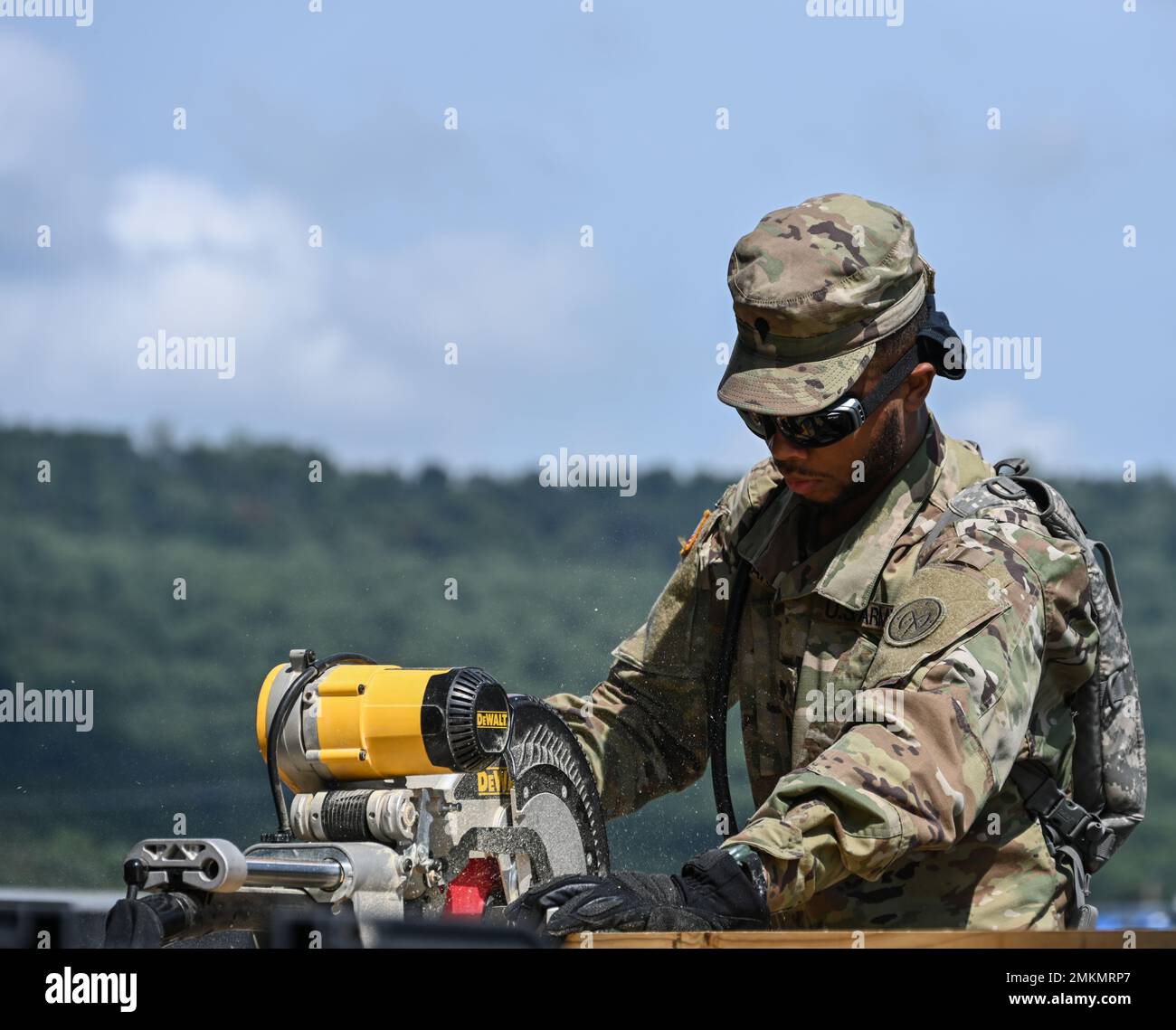 Specialist Kamron Harris, of the 152nd Engineer Battalion, cuts wood ...