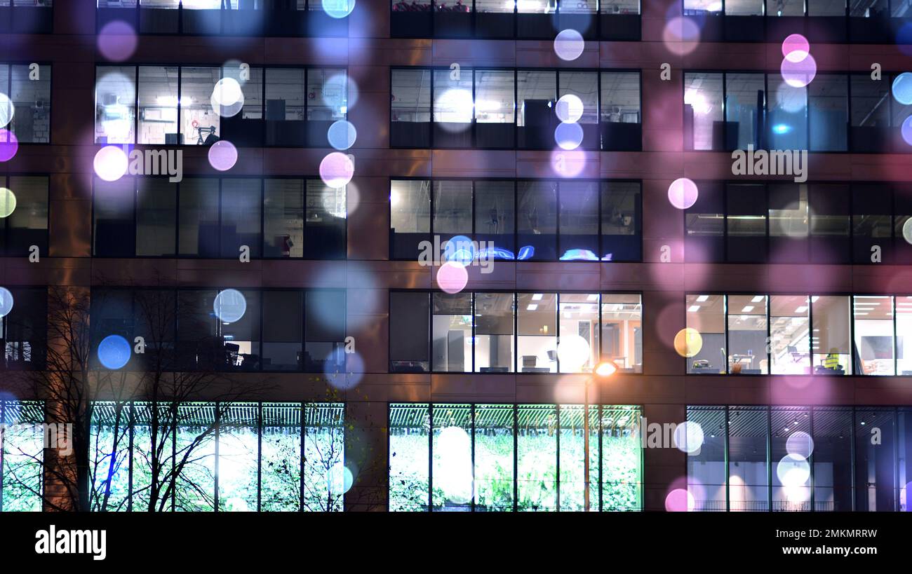 Pattern of office buildings windows illuminated at night. Glass ...