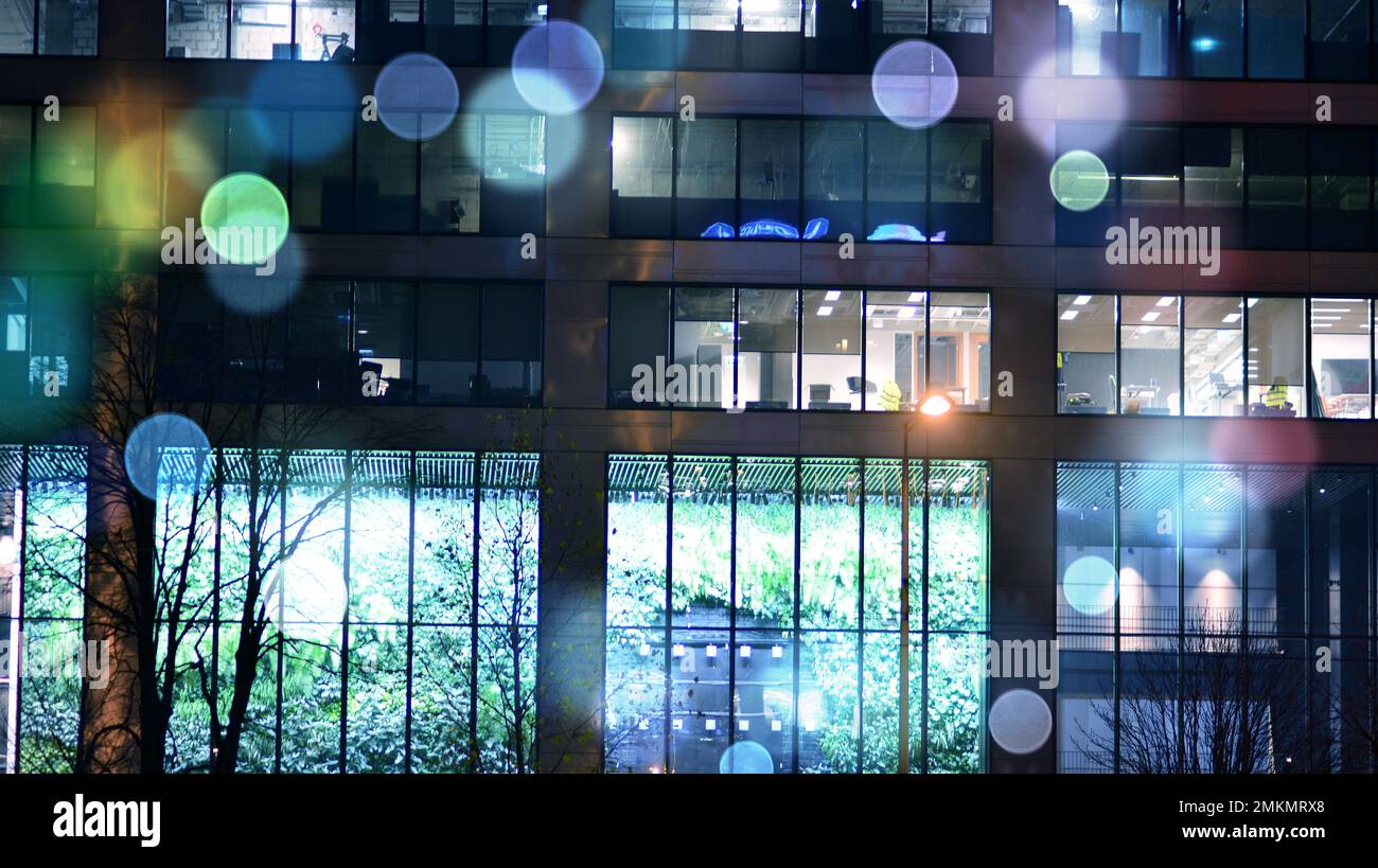 Pattern of office buildings windows illuminated at night. Glass ...