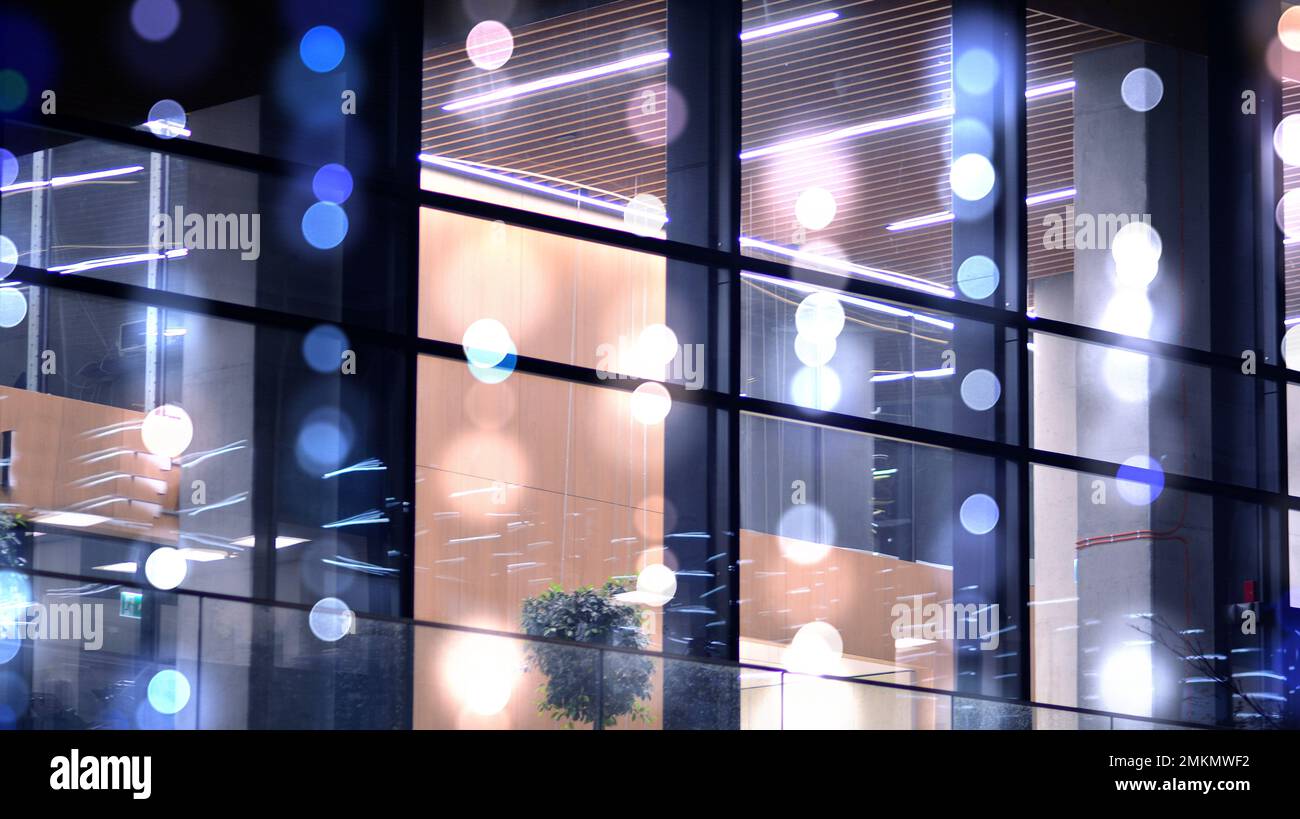 Pattern of office buildings windows illuminated at night. Glass ...