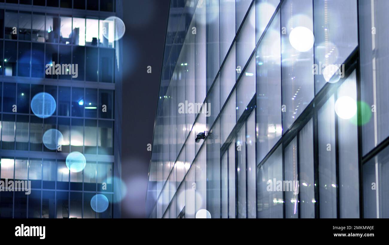 Pattern of office buildings windows illuminated at night. Glass ...