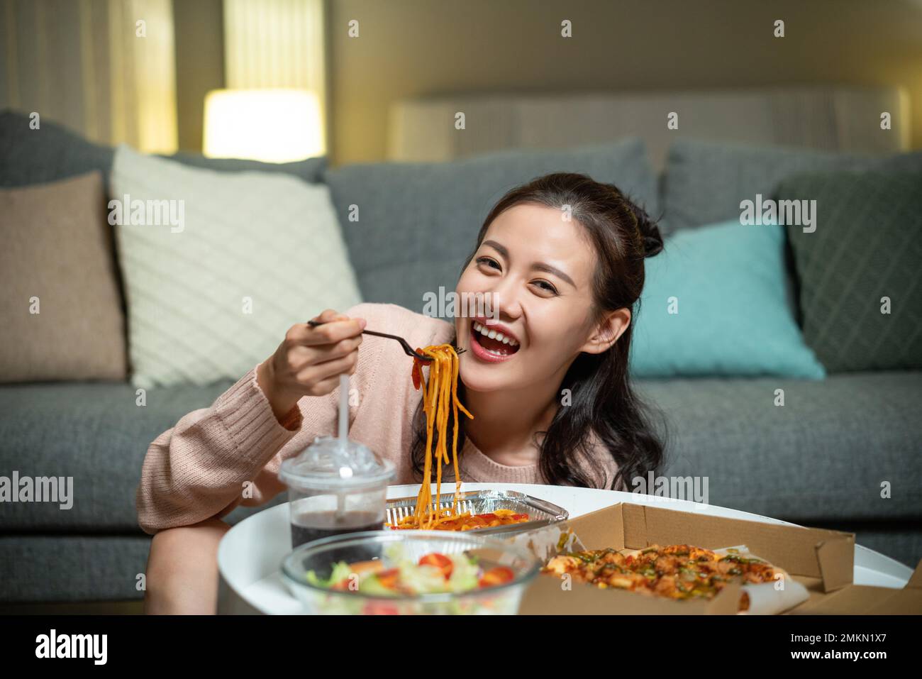 The young lady at home eating take-away Stock Photo - Alamy