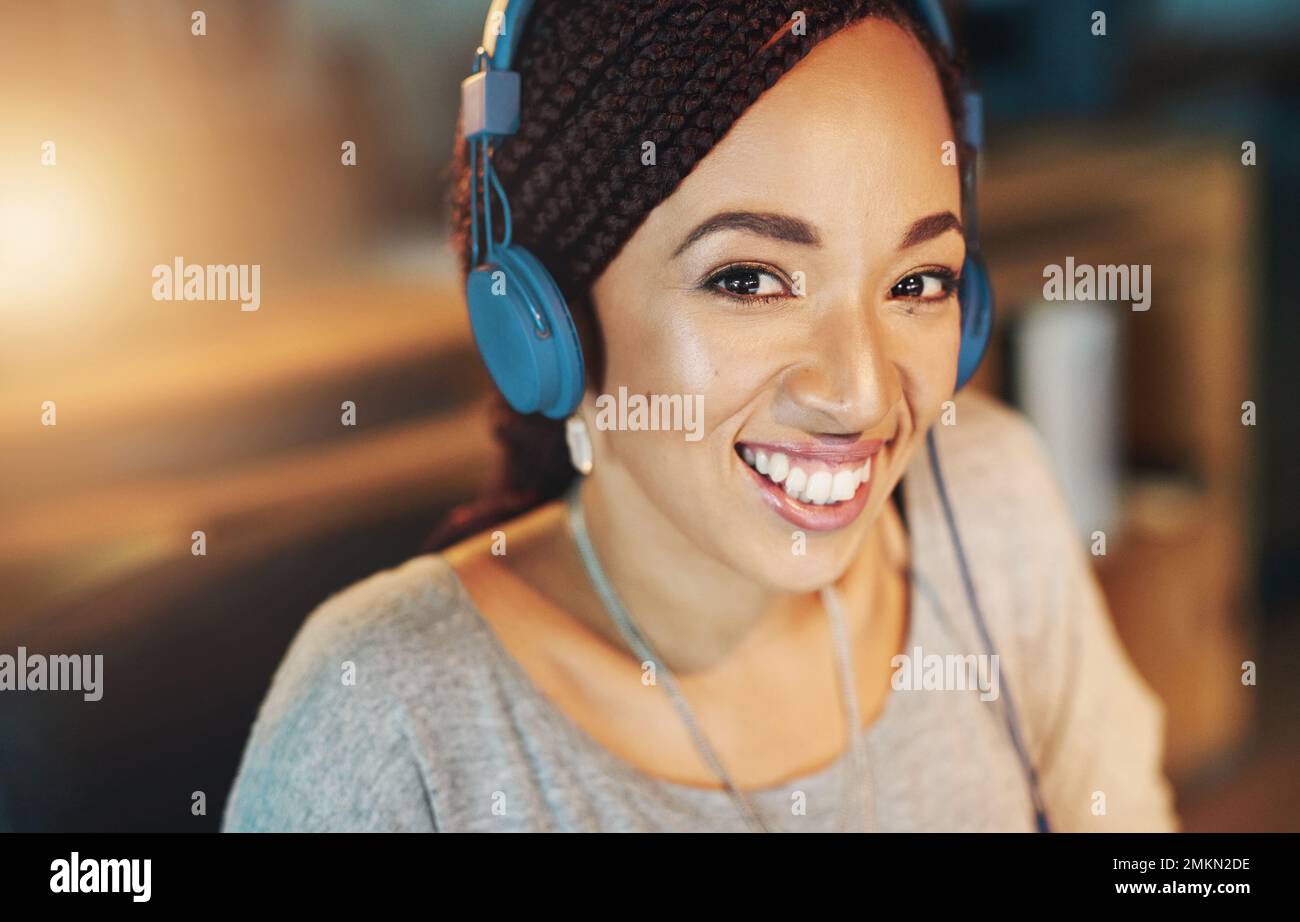 You gotta have music if youre working late. Cropped portrait of a young ...