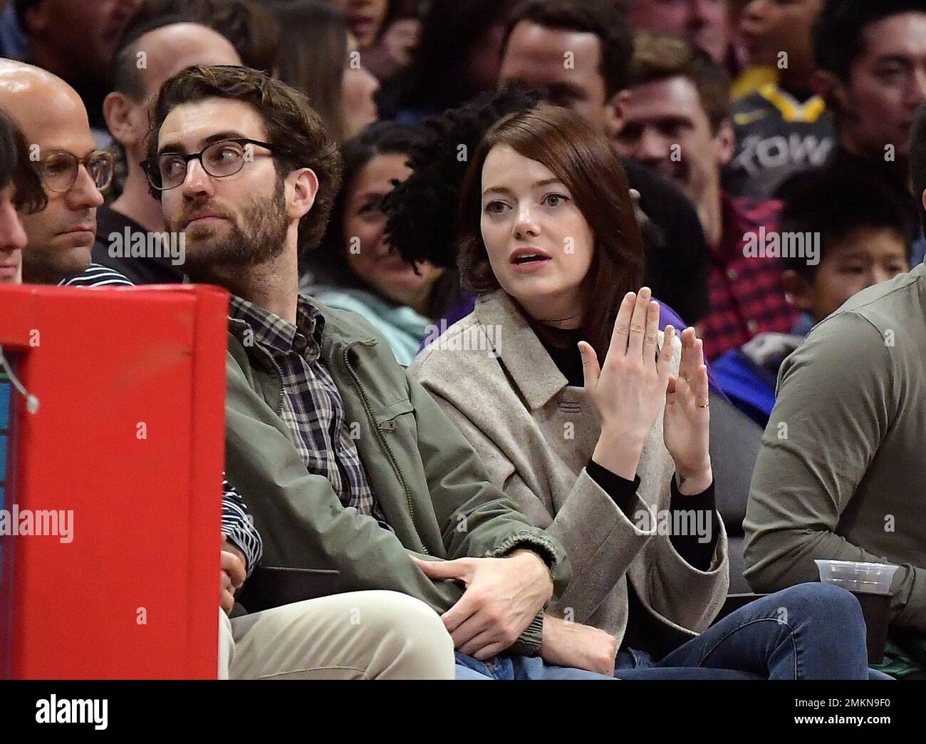 Actress Emma Stone, right, and Dave McCary watch during the second half ...