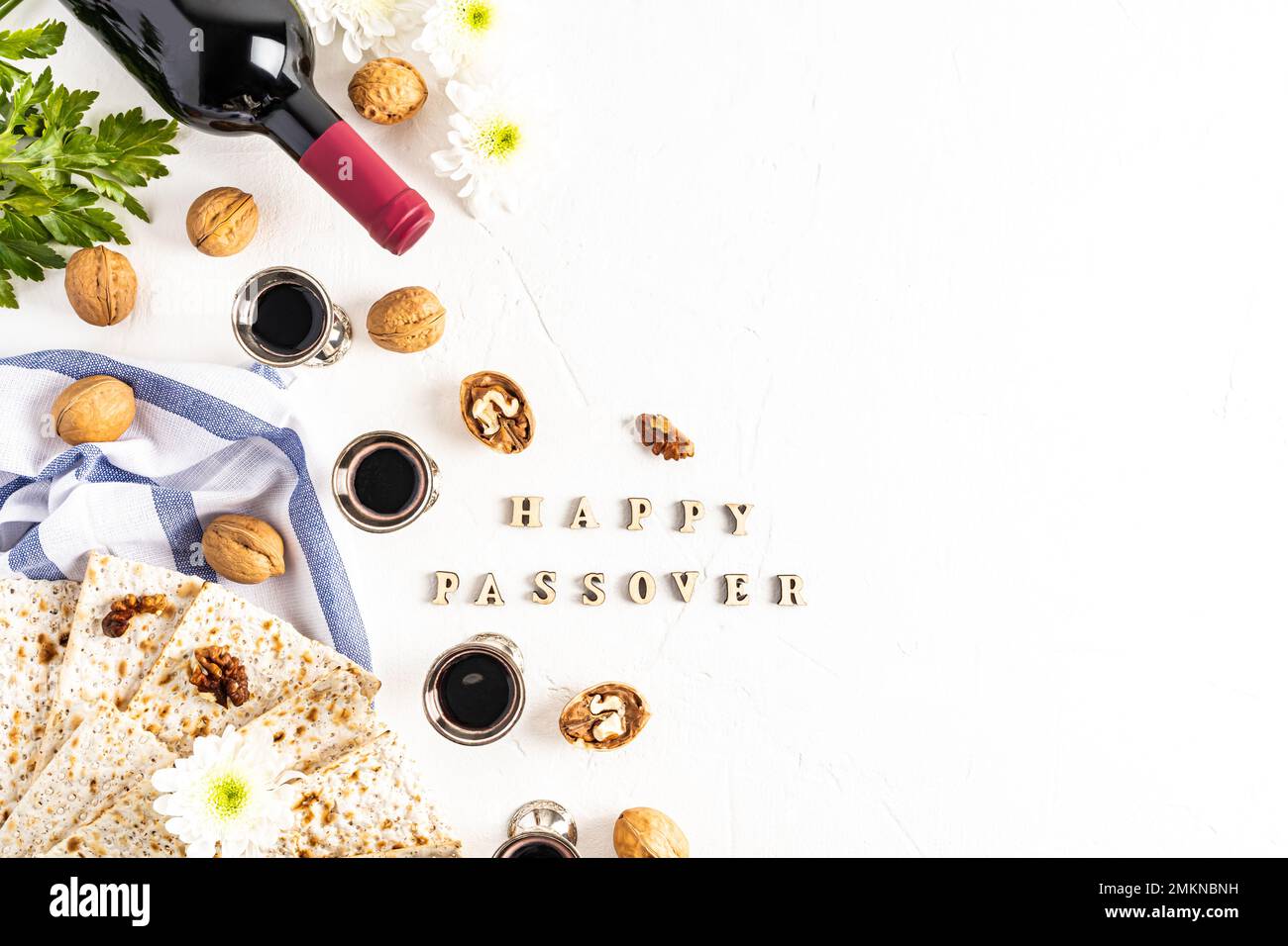 festive background of the Jewish Passover with matzah, red kosher wine ...