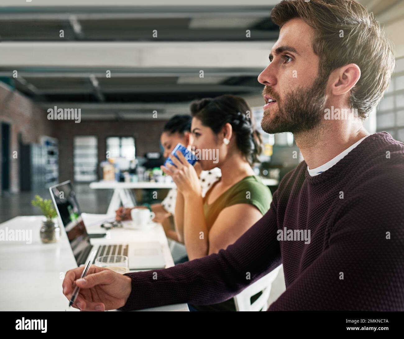 Fully engaged in their meeting. a team of colleagues having a meeting ...